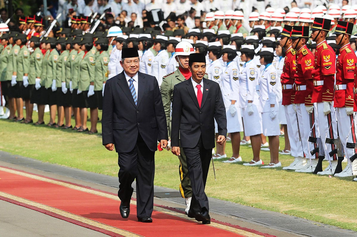 Indonesia's Widodo takes office, reaches out to foes